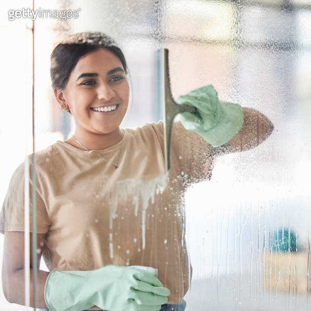 Happy, smile and girl cleaning window with spray bottle and soap or ...