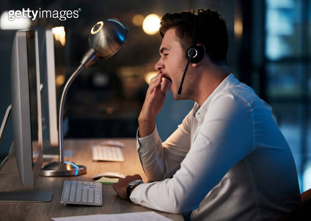 Tired, yawn and call center man in office at night for telemarketing ...