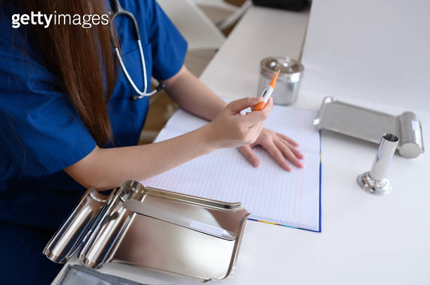 Focus on doctor's hands holding fever testing equipment (1773613047 ...