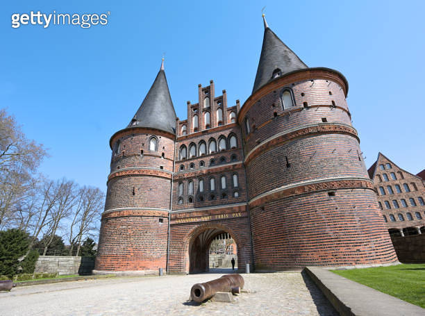 Lubeck Holstentor (Holsten gate) with canon, famous historic landmark ...
