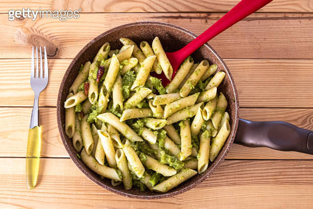 Above view of a pan on wooden background filled with healthy and vegan ...