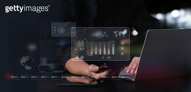 A woman programmer analyzes and develops software on a futuristic virtual interface screen while ...