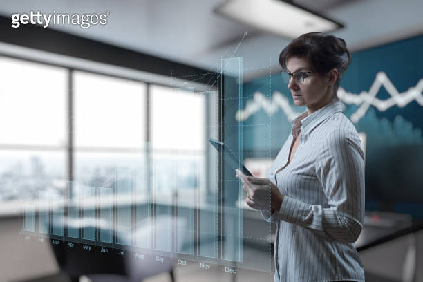 Businesswoman doing financial market analytics in the office. 이미지 ...