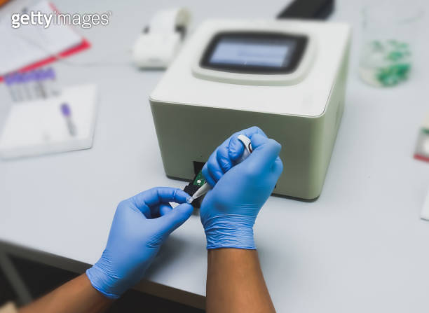 Scientist pipetting sample for PCR test at PCR machine. pipette into ...