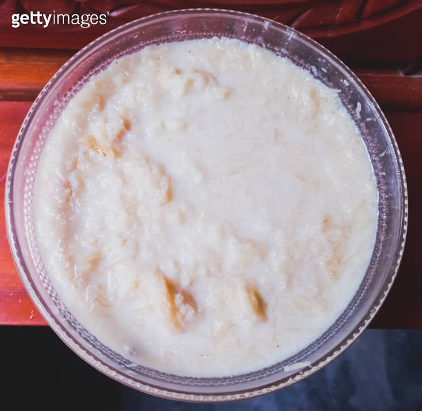 Rice kheer Tasty rice pudding with nuts and raisins in a bowl close ...