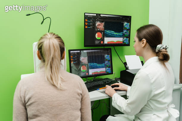 Examination of eyes of patient using optical coherence tomograph ...