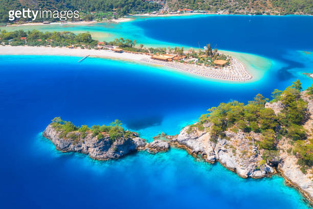 Aerial view of sea bay, rock, sandy beach, trees, mountain at sunny day ...