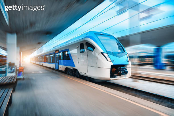 Blue high speed train in motion on the railway station. Fast moving ...
