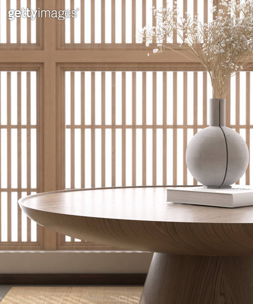 Round wood table counter podium, white flower bouquet in gray vase on ...