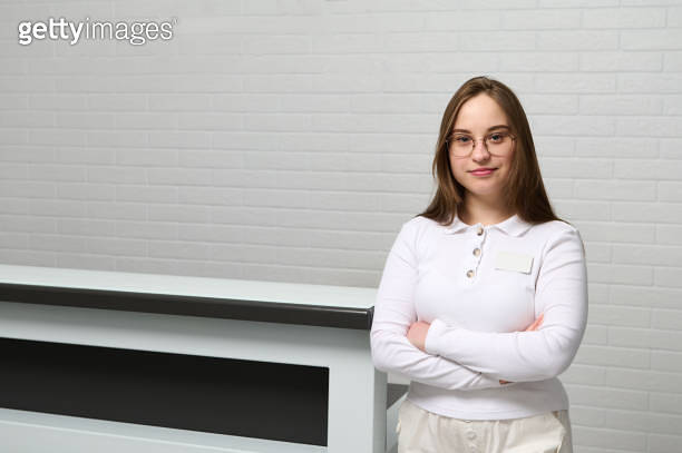 Confident medical assistant, receptionist at reception counter with ...