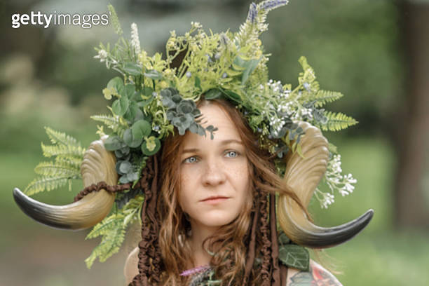 A pretty young faun in the woods. Mythological forest creature at the ...