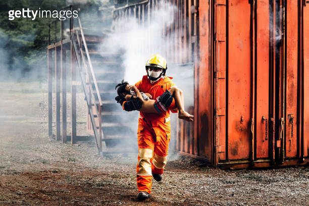 Firefighter to save girl in fire and smoke. Rescue Team or Firefighters ...