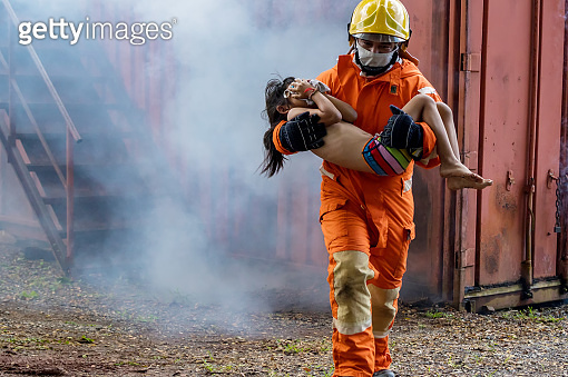 Firefighter to save girl in fire and smoke. Rescue Team or Firefighters ...