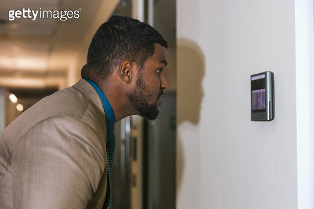 Man using face scanner to unlock door in office building. Access ...