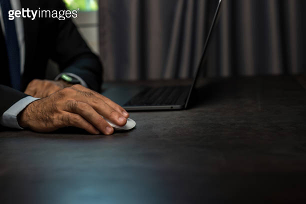 Man using computer mouse. Close up of hand using on white mouse and ...