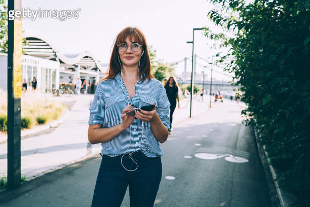 Full length portrait of beautiful caucasian woman in eyewear enjoying ...