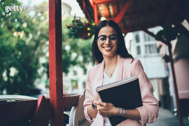 Half length portrait of cheerful female journalist with sketchbook ...