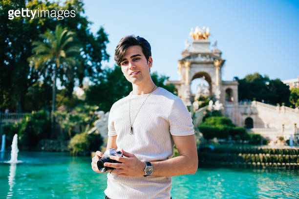 Portrait of handsome positive caucasian male looking at camera standing ...