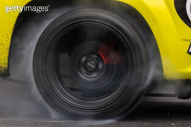 Drag car burning tire, Warm up tire before competition, Drag car wheel ...