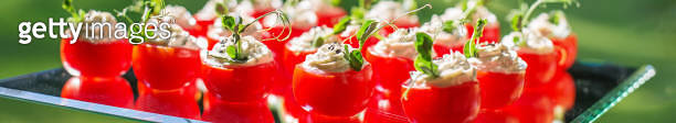 catering buffet table with snacks and appetizers. Stuffed cherry ...