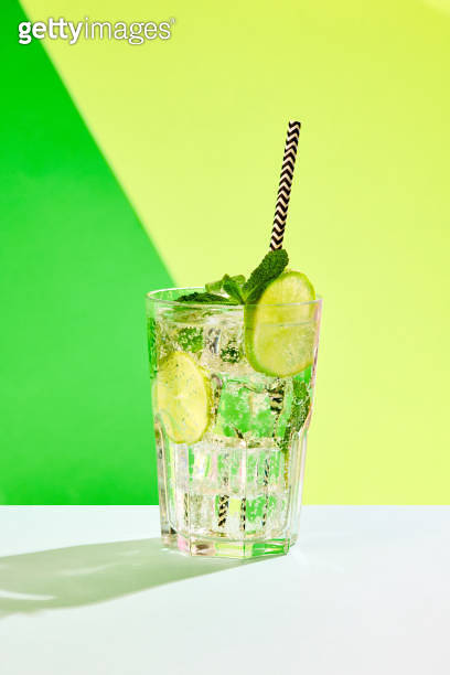 Poster. Lively lemonade with lime slices showcased against vibrant ...