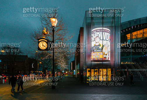 Exterior architecture of Tottenham Hotspur stadium illuminated at night ...