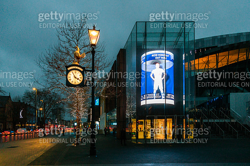 Exterior architecture of Tottenham Hotspur stadium illuminated at night ...