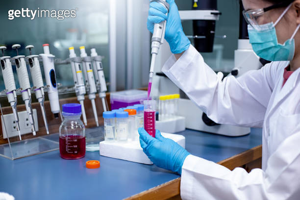 Scientist use a micropipette with sample preparation in the laboratory ...