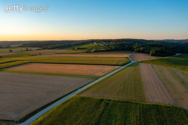 Aerial view landscape with multiple agricultural fields in the evening ...