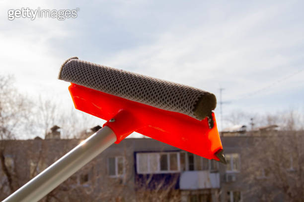 Window washing. Cleaning the window with a brush and foam. The concept ...