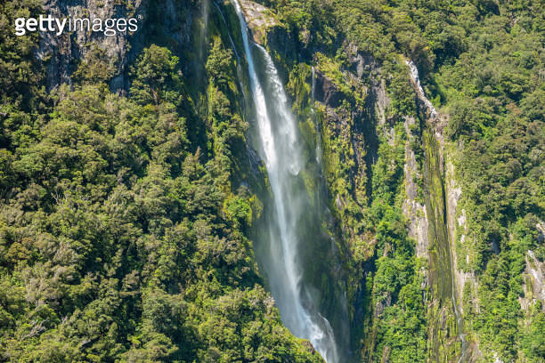 Magnificent waterfall, Milford Sound (Piopiotahi) fjord, Fiordland ...