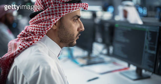 Portrait of a Middle Eastern Engineer Working on Desktop Computer in a ...