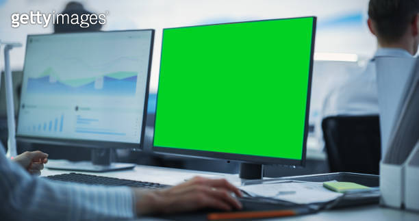 Close Up on Computer Monitor Green Screen Display in a Business Office ...