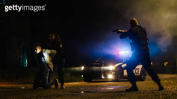 Two Police Officers Catch and Put Suspect Under Arrest. Cops Aiming ...