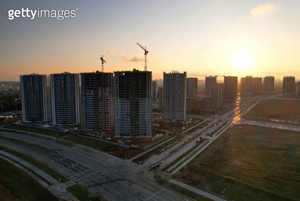 Construction site with tower cranes on sunset, aerial view. Building ...