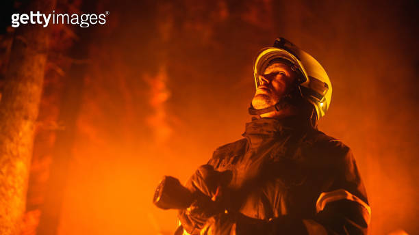 Experienced Firefighter Extinguishing a Wildland Fire Deep in the Woods ...