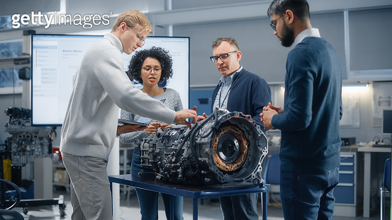 Intelligent Black Woman Talks to Diverse Colleagues While Working ...