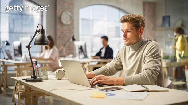 Diverse Multiethnic Creative Team Working On Computers in Bright Office ...