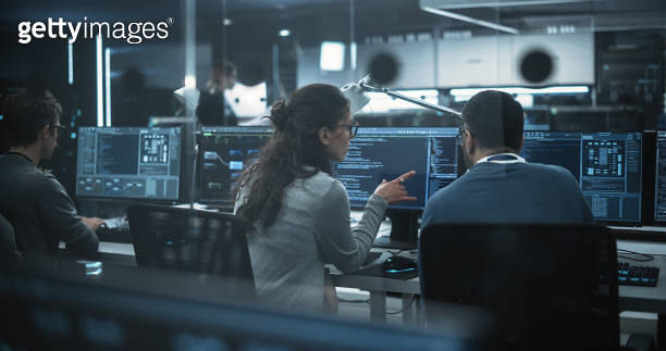 Diverse Young Colleagues Working on Computers in a Research Laboratory ...