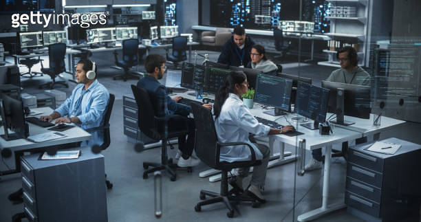 Diverse Young Indian Colleagues Working on Computers in a Research ...