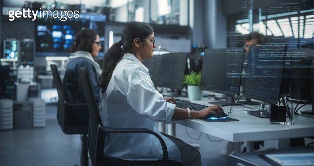 Diverse Young Indian Colleagues Working on Computers in a Research ...