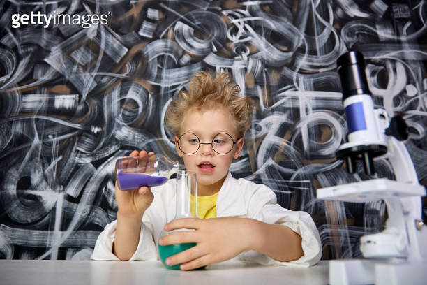 Careful cautious child observes result of a chemical test in a home ...