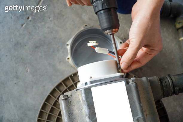 electric servo motor,Repairman using cordless screwdriver removing ...