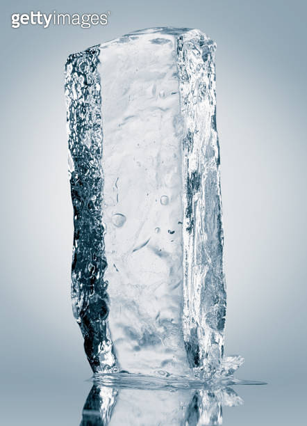 Crystal clear natural ice block in light blue tones on a white ...