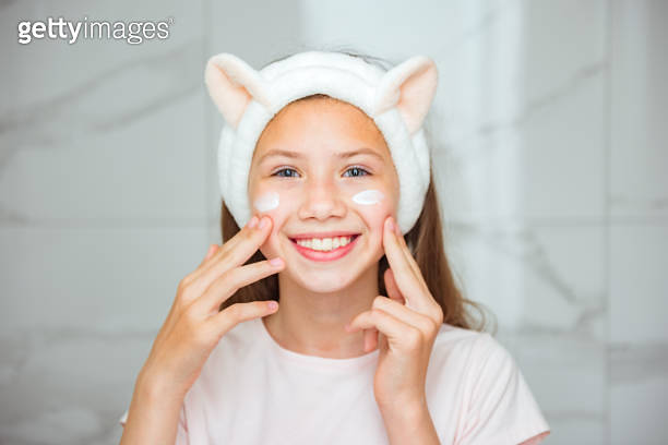 Teen girl washing face in morning in bathroom. Self Care morning ...