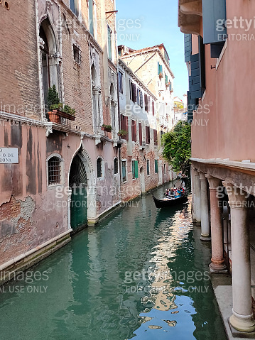 Tourists floating in a gondola in Venice with canal and old buildings 이미지 (1760118060) - 게티이미지뱅크