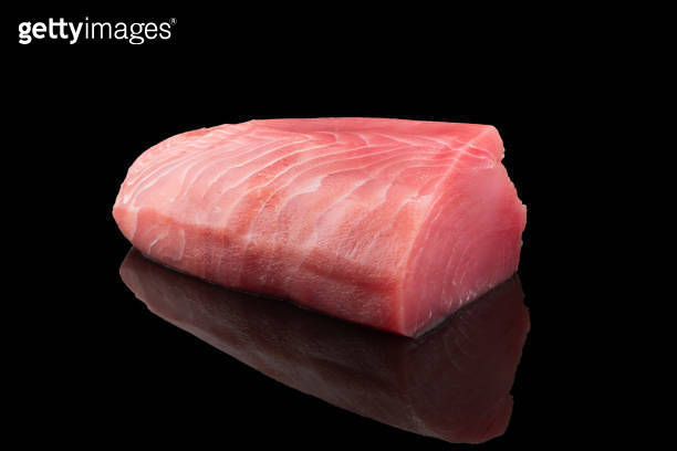 Yellow fin tuna steak isolated on black background. Fresh rare tuna ...