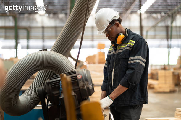 African American technician craft man working with machine at wood ...