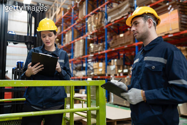 Caucasian businesswoman with buddy workers using clipboard checking ...