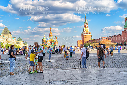 People walk around Red Square, St. Basil's Cathedral, the Spasskaya ...